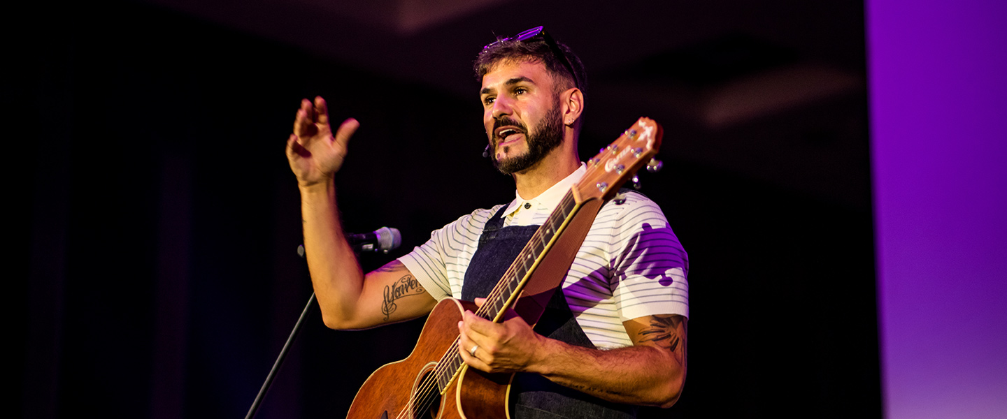 Musician J'Something on stage with his guitar